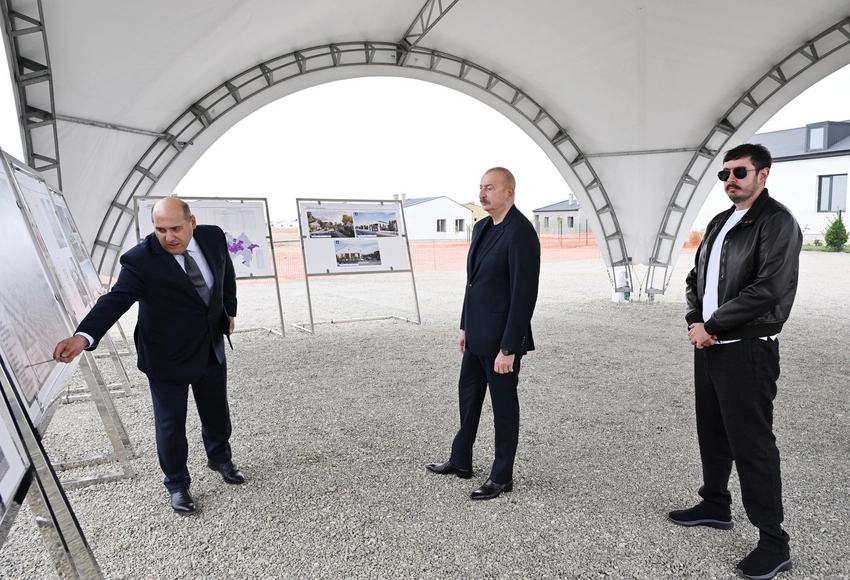 President Ilham Aliyev and his son Heydar Aliyev view progress of ...